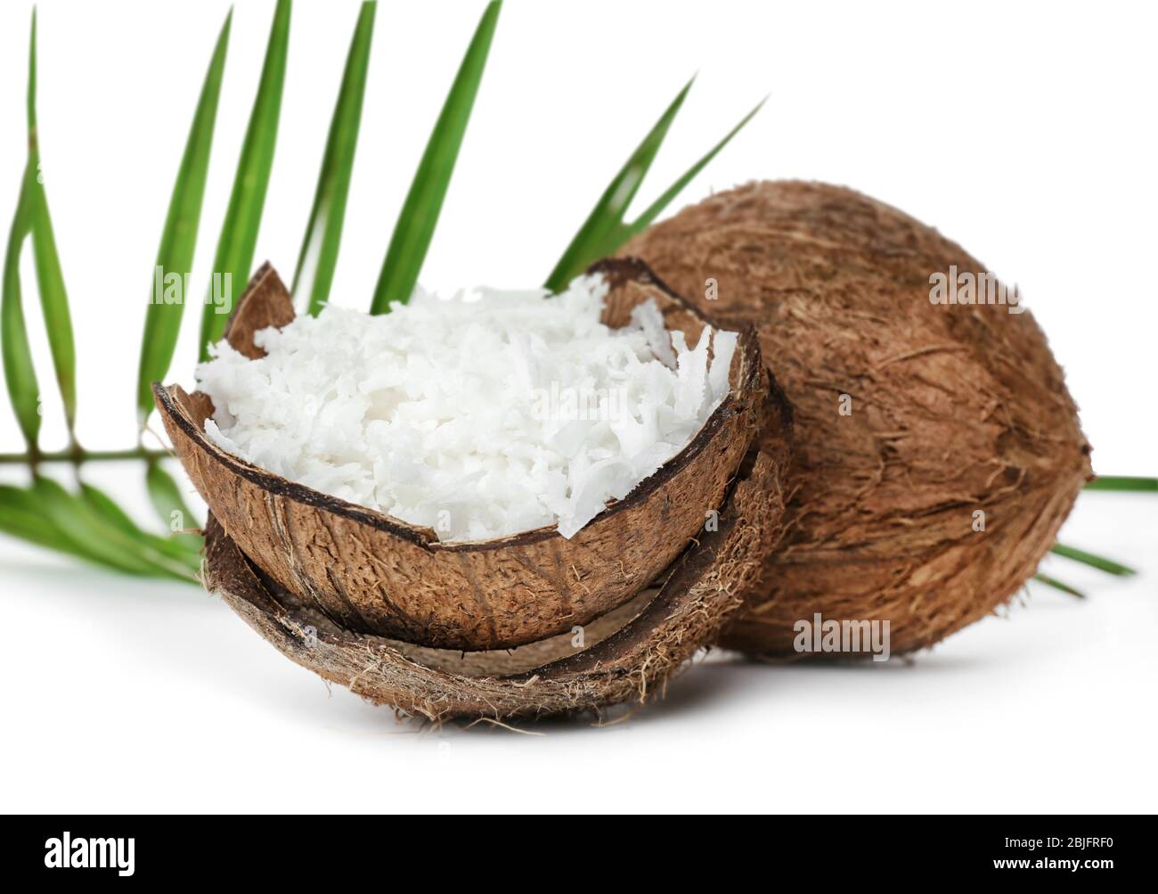 Grated coconut in shell and whole nut on white background Stock Photo ...