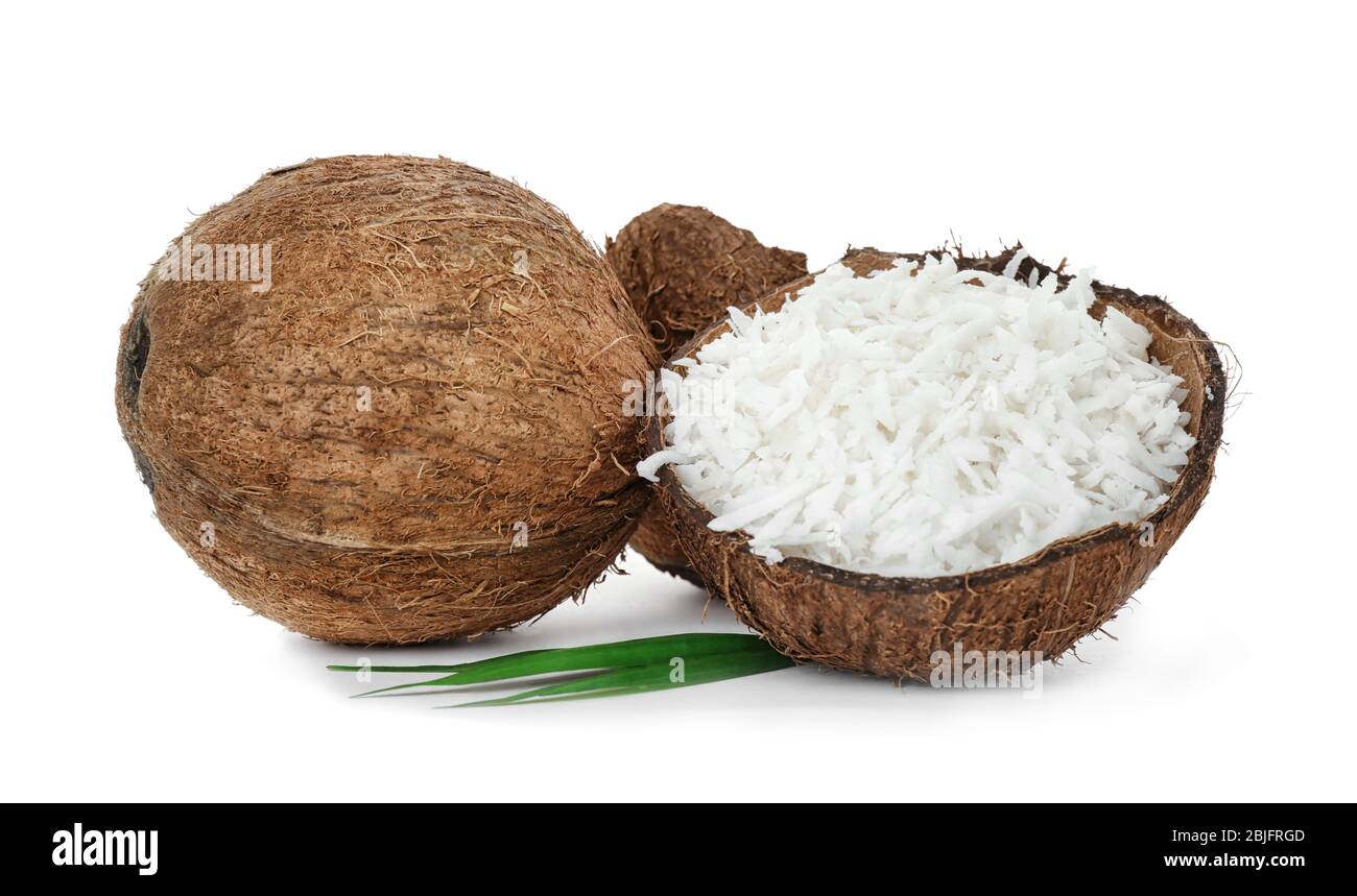 Grated coconut in shell and whole nut on white background Stock Photo ...