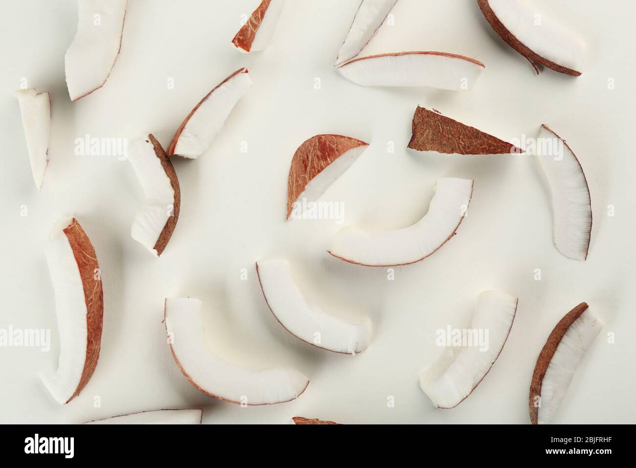 Coconut pieces on white background Stock Photo - Alamy