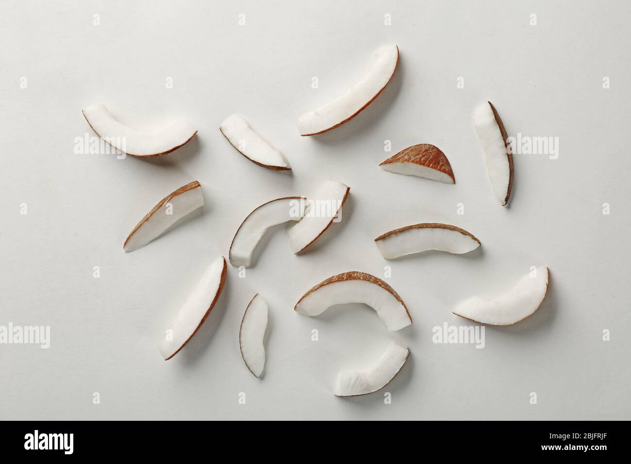 Coconut pieces on white background Stock Photo - Alamy
