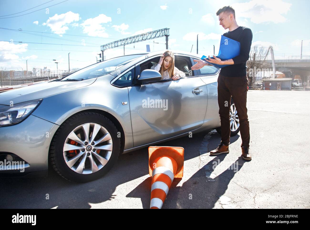Driving instructor and woman student in examination car Stock Photo - Alamy