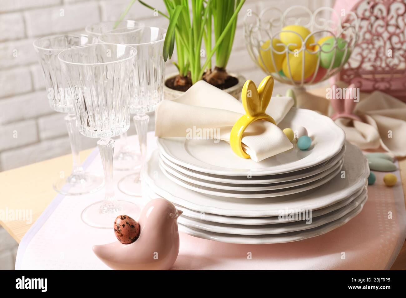 Beautiful Easter table setting with white plates Stock Photo - Alamy