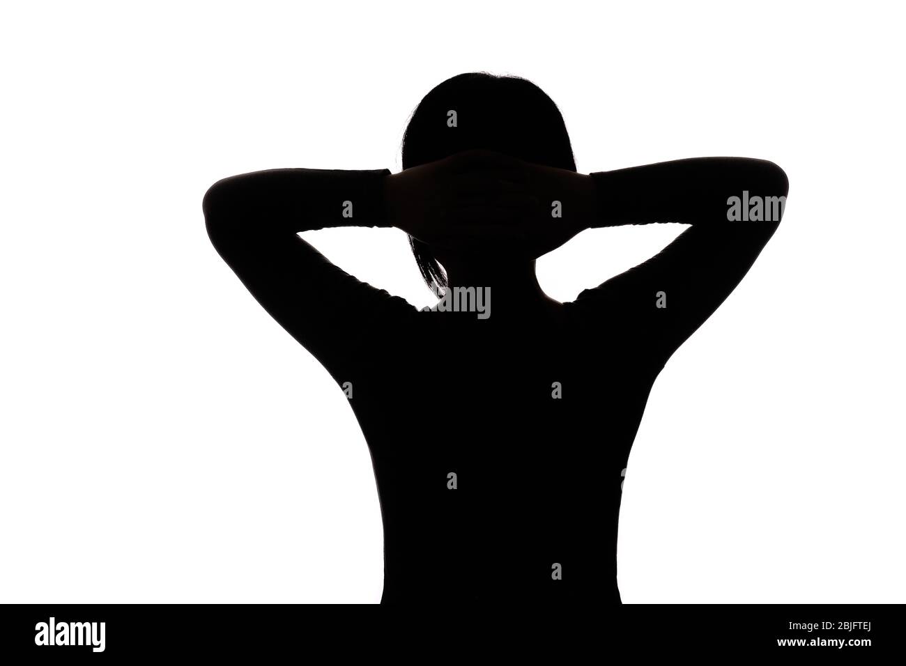 Black backlit silhouette of head and shoulders of an oriental woman ...