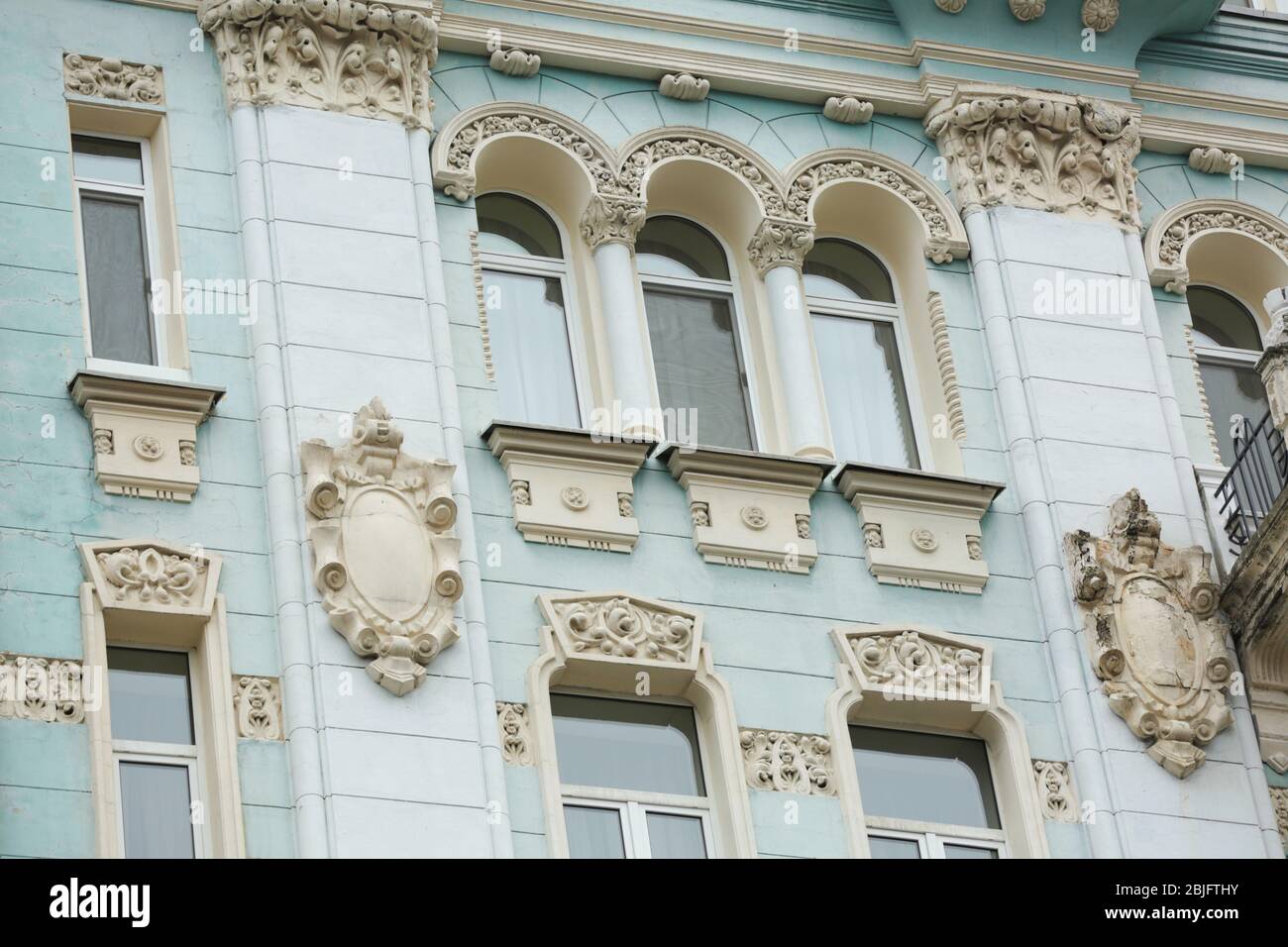 Ornate building with white plastic windows Stock Photo - Alamy
