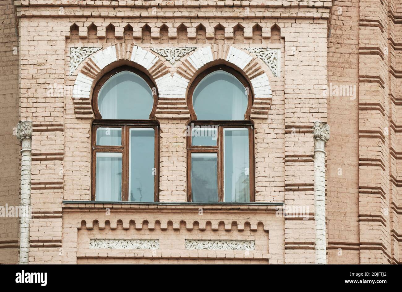 Ornate building with vintage arched windows Stock Photo - Alamy