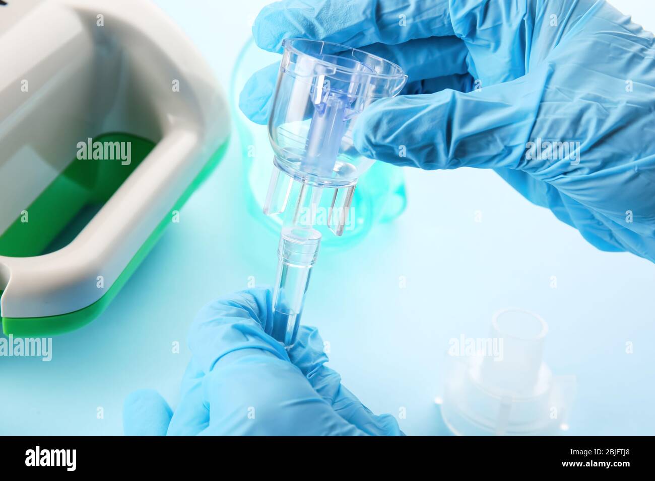 Doctor preparing compressor nebulizer for use, closeup Stock Photo - Alamy