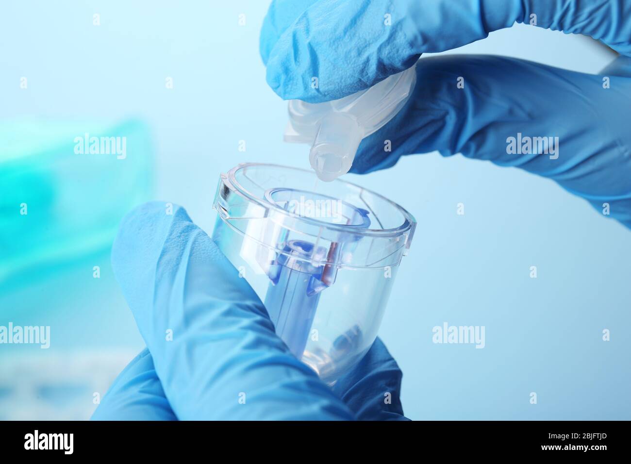 Doctor filling medication cup with remedy for inhalation therapy Stock ...