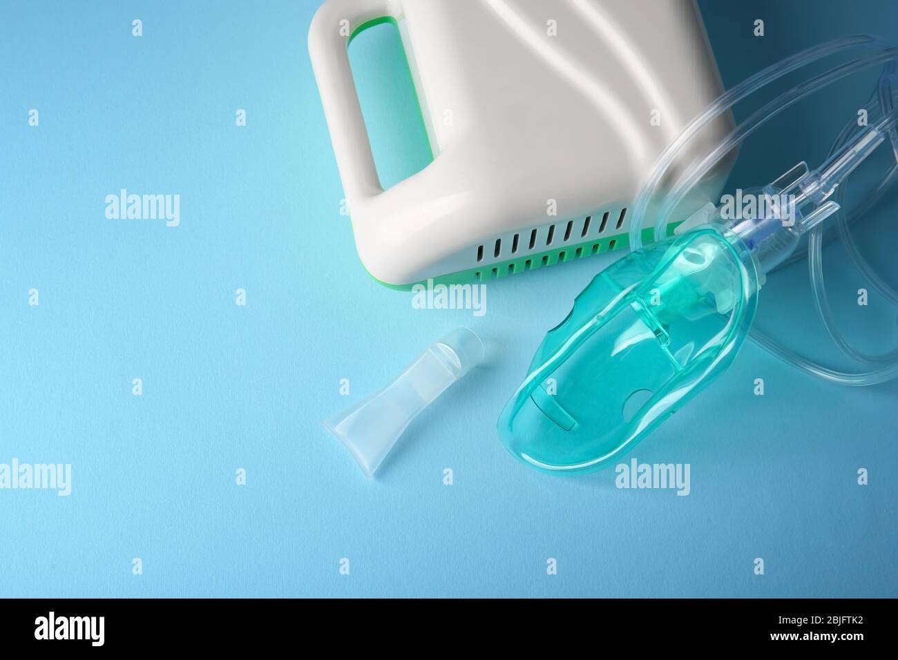 Compressor nebulizer with mask on color background Stock Photo - Alamy