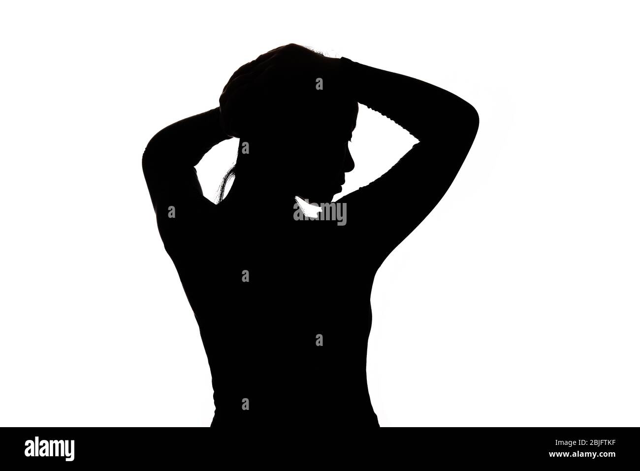 Black backlit silhouette of head and shoulders of an oriental woman ...