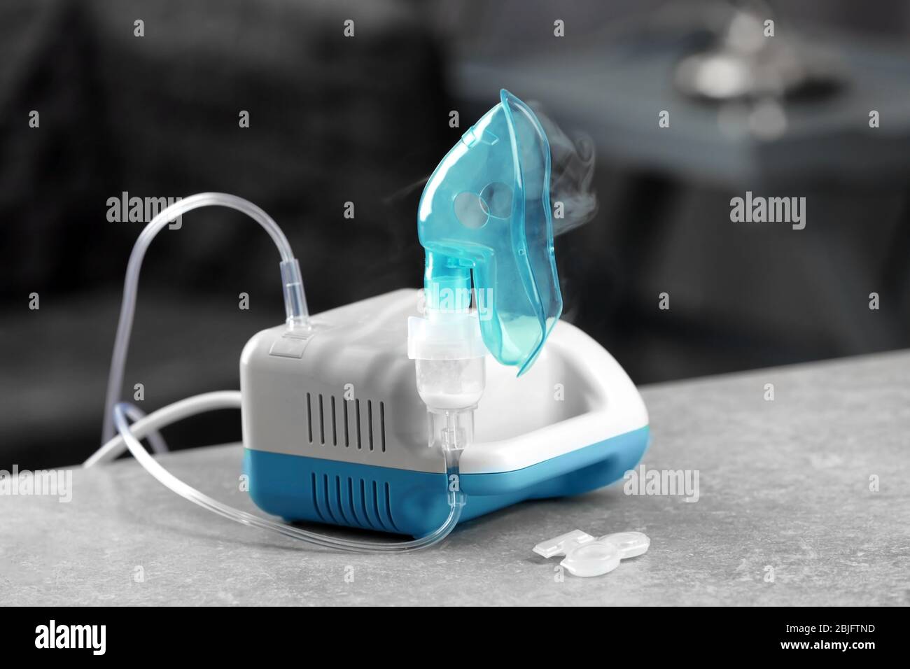 Compressor nebulizer with mask on table Stock Photo - Alamy