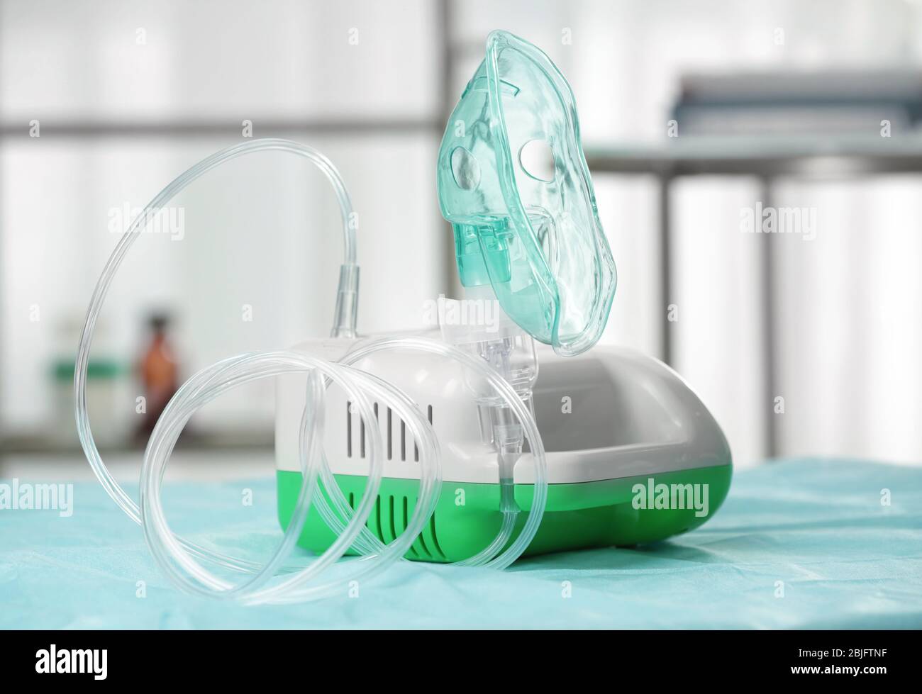 Compressor nebulizer with mask on table Stock Photo - Alamy