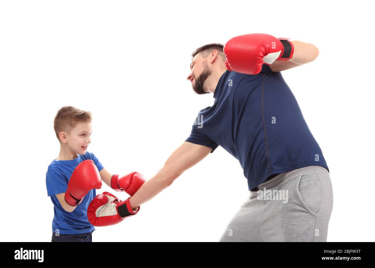 Father and son during boxing training, on white background Stock Photo ...