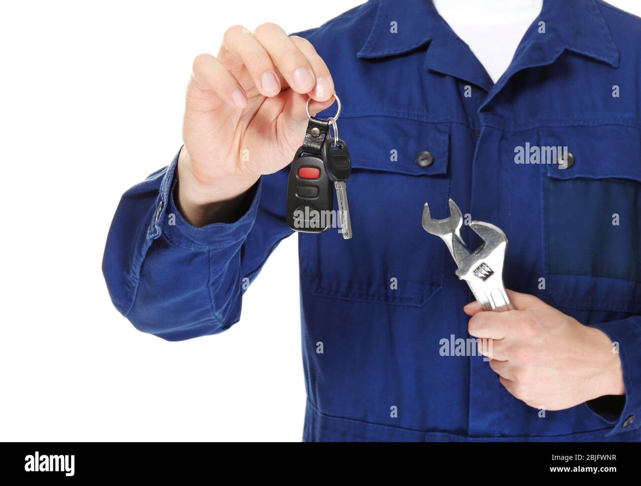 Auto mechanic with car key and tools on white background, closeup Stock ...