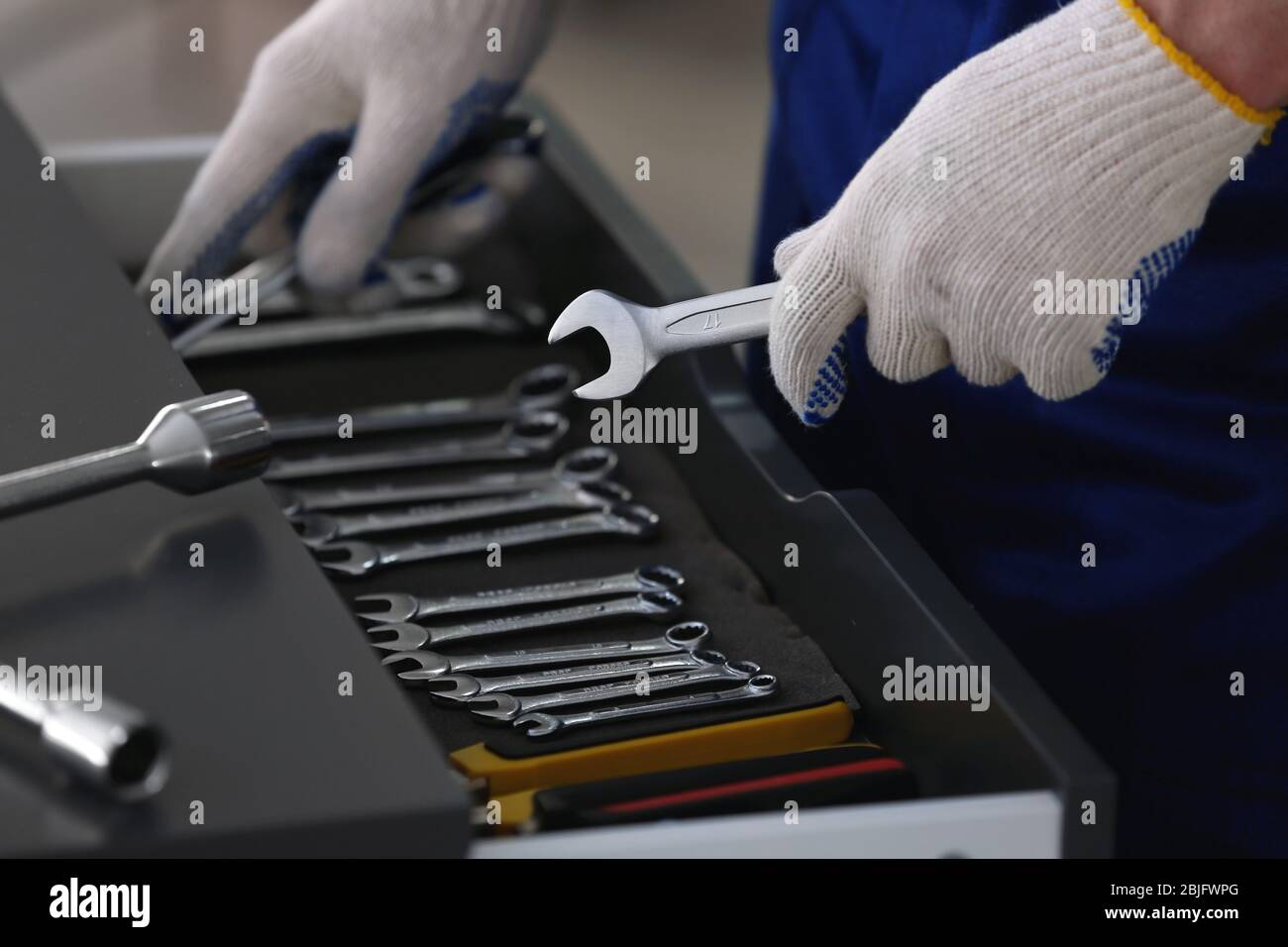 Auto mechanic selecting tools in car repair shop, closeup Stock Photo ...