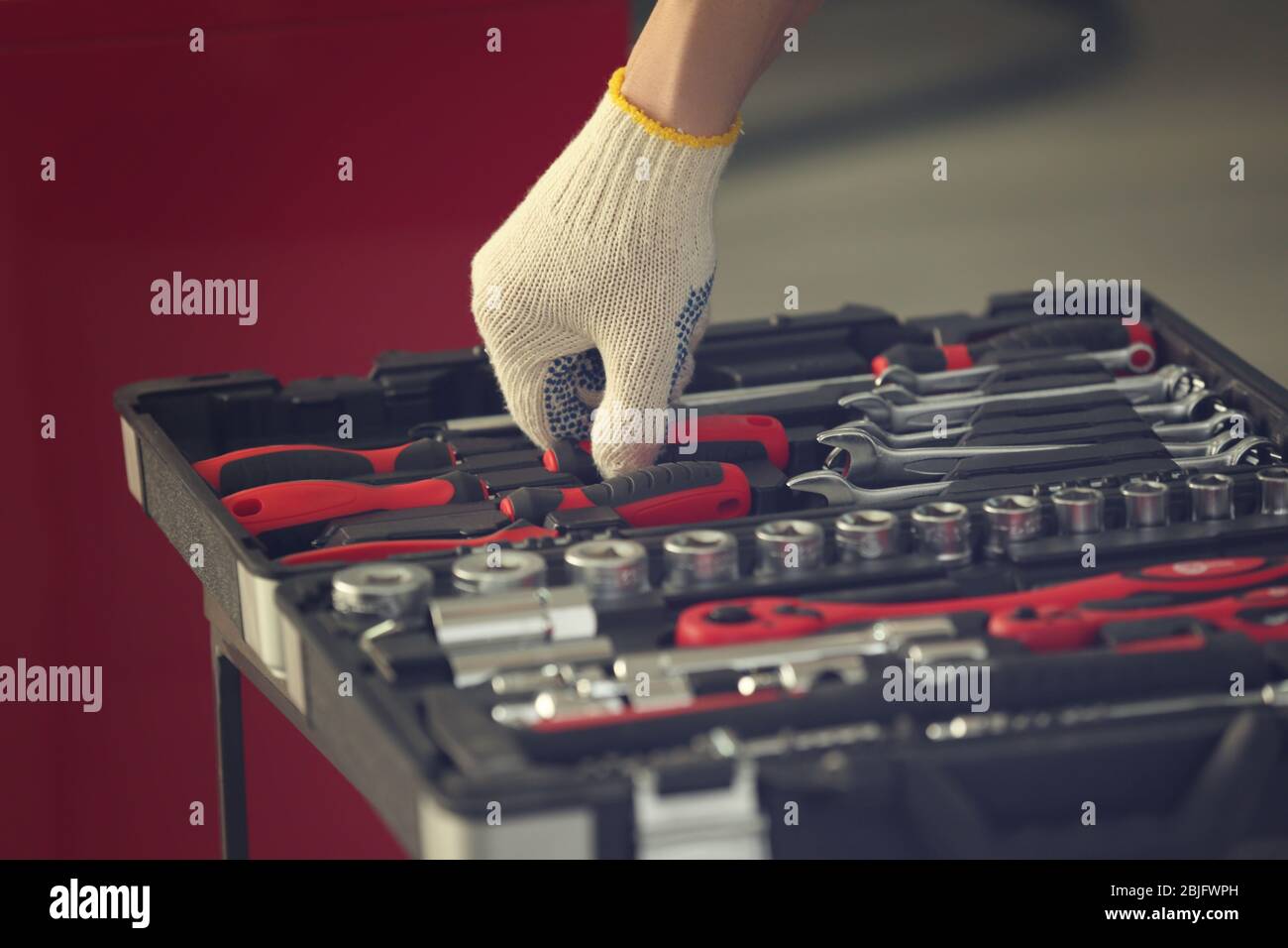 Auto mechanic selecting tools in car repair shop, closeup Stock Photo ...