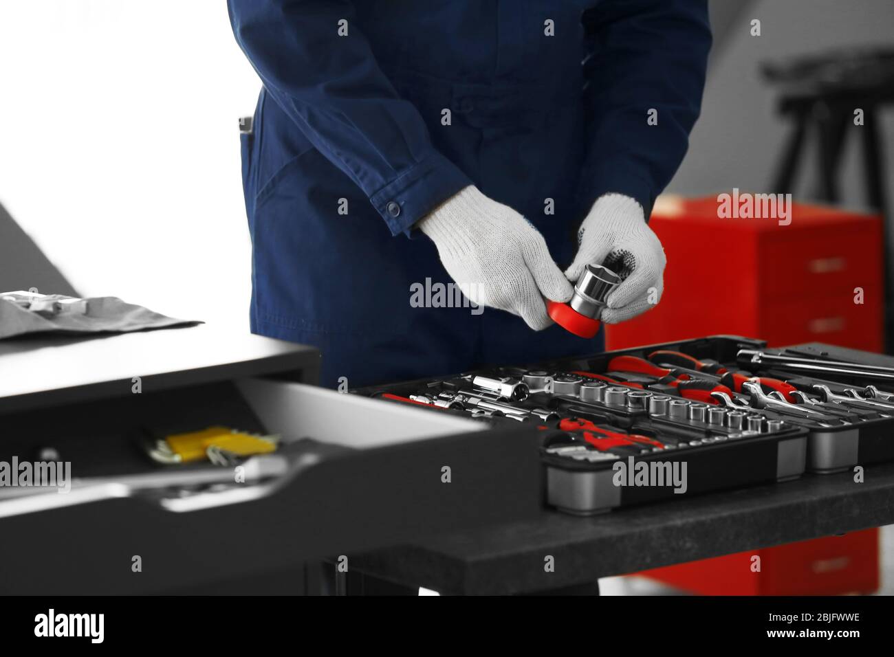Auto mechanic with tools in car repair shop, closeup Stock Photo - Alamy