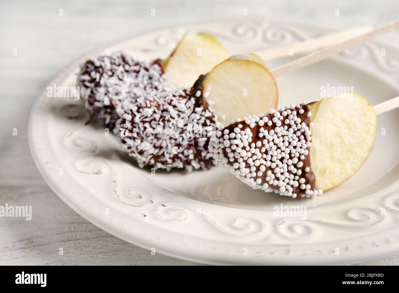 Plate with candied apple wedges on sticks Stock Photo - Alamy