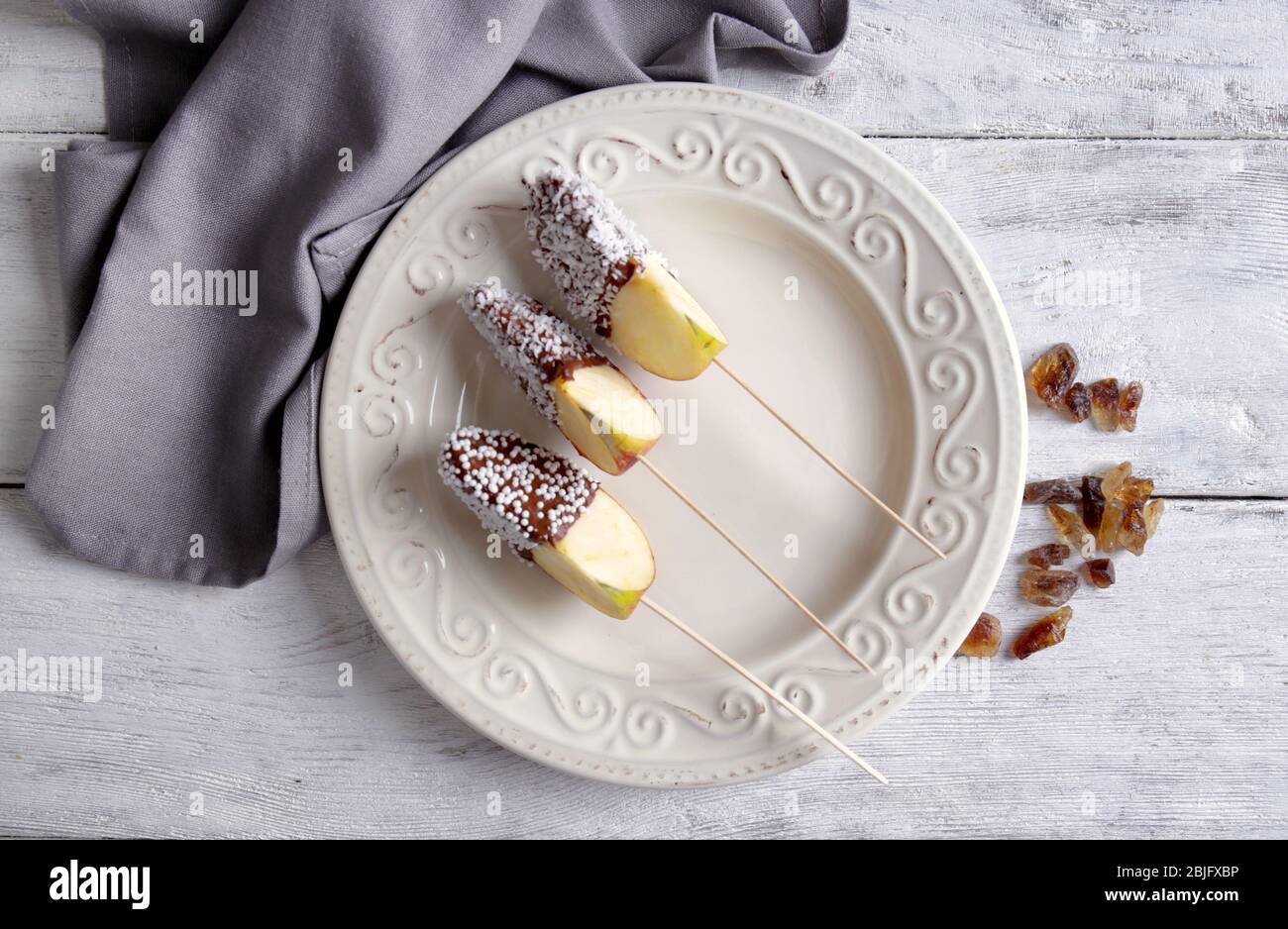 Plate with candied apple wedges on sticks Stock Photo - Alamy