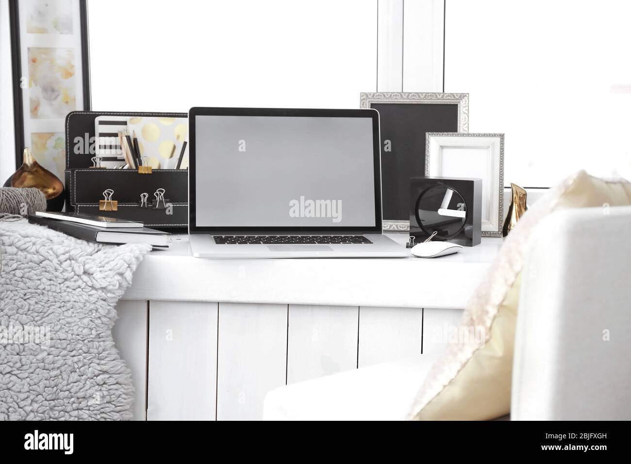 Creative workplace with laptop on windowsill in modern room Stock Photo ...