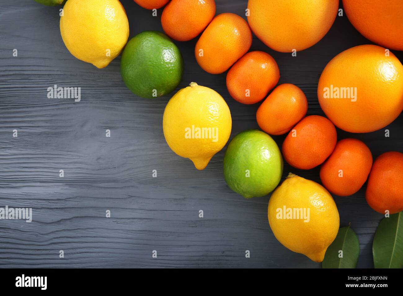 Beautiful composition of citrus fruits on wooden background Stock Photo ...