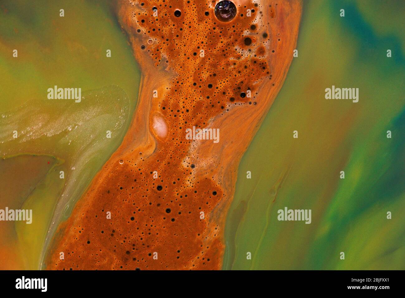 Brown liquid from mixed colors. Waves and patterns of bright colors ...