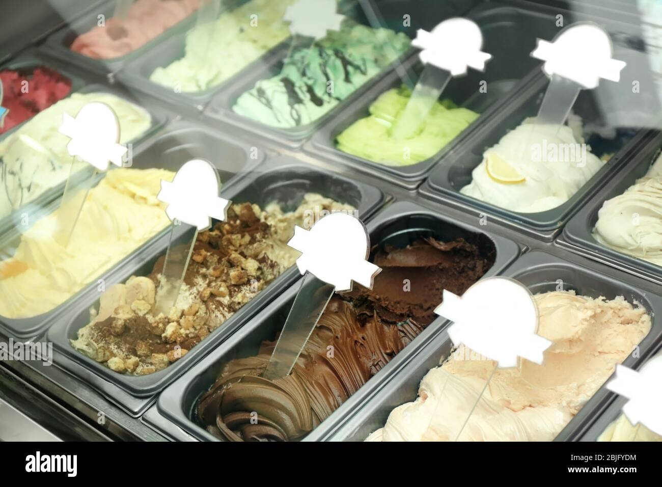 Showcase of different ice cream in metal tubs, closeup Stock Photo - Alamy