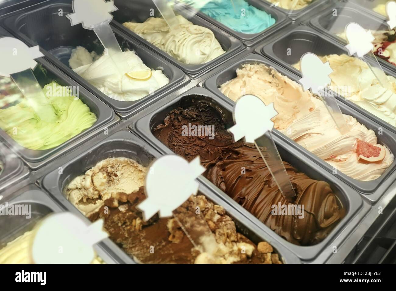 Showcase of different ice cream in metal tubs, closeup Stock Photo - Alamy