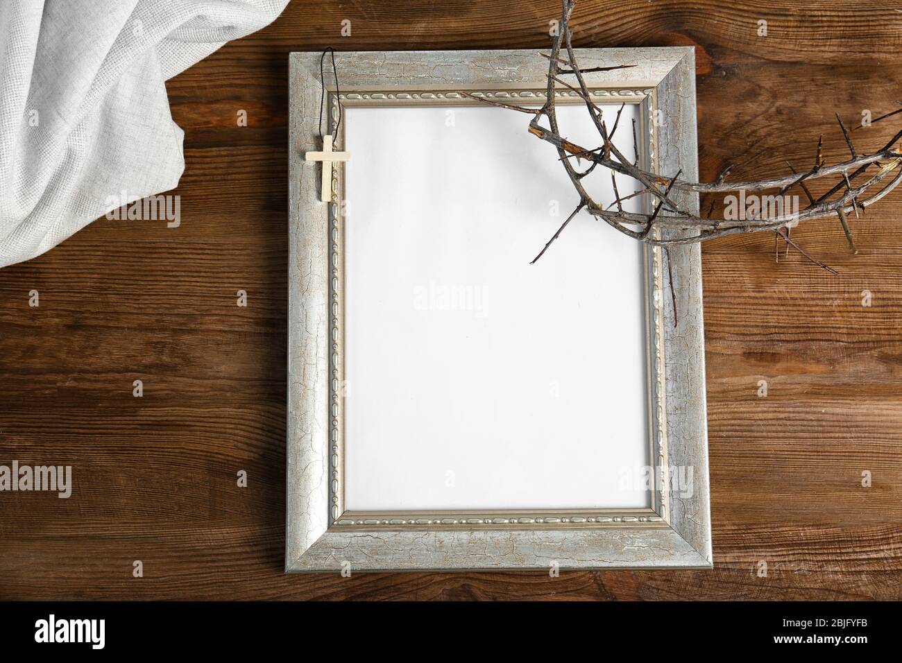 Photo frame, crown of thorns and cross on wooden background Stock Photo ...