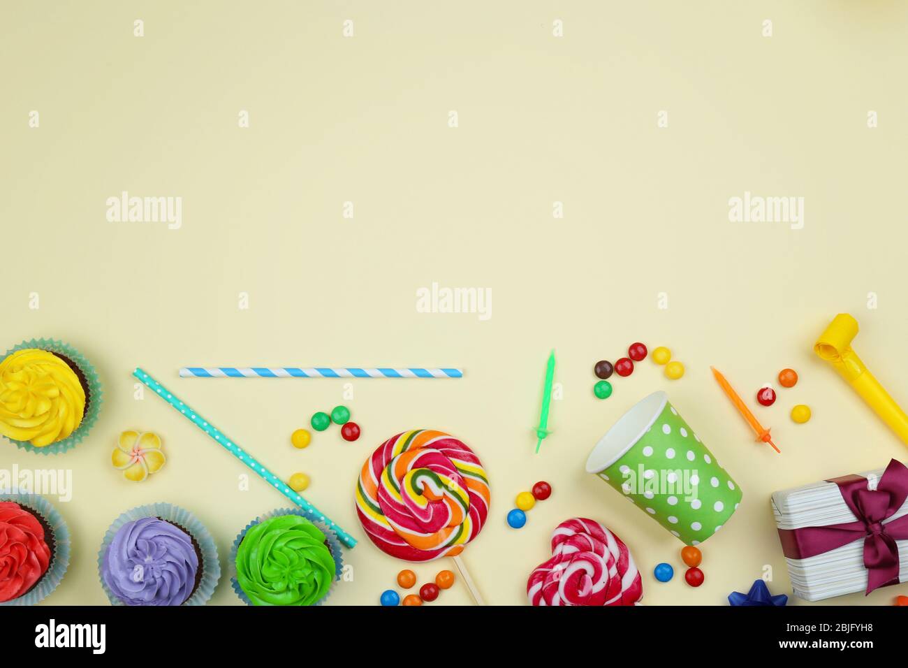 Bright birthday decor on color background Stock Photo - Alamy