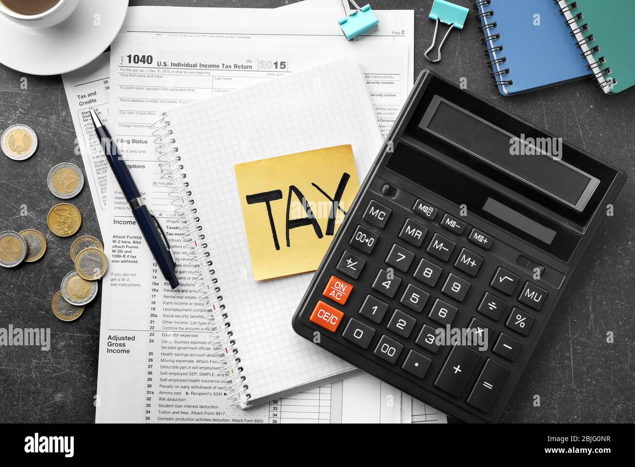 Paper sheet with text TAX, notepad, calculator and individual income ...