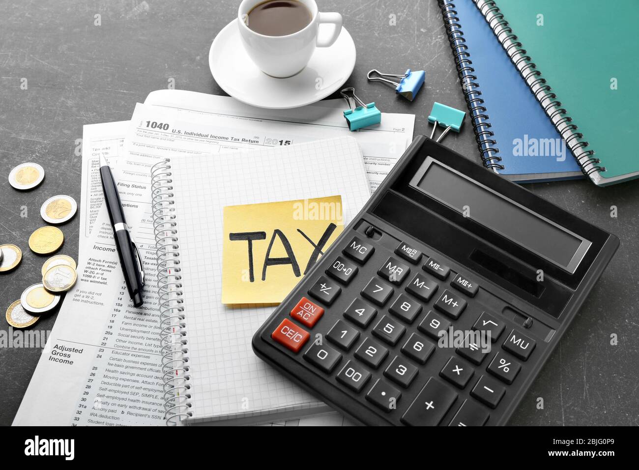 Paper sheet with text TAX, notepad, calculator and individual income ...