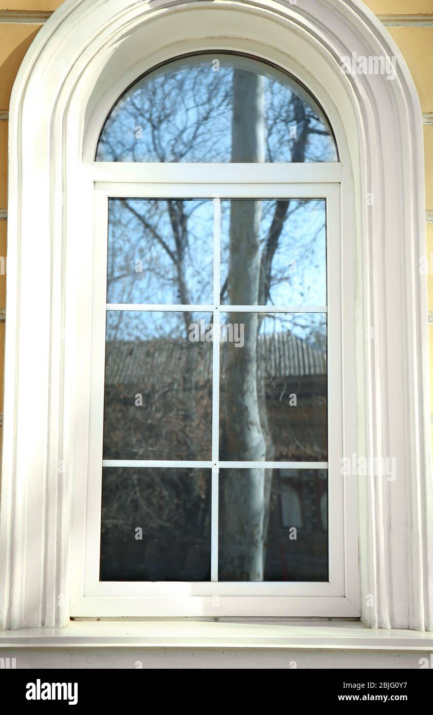 Vintage building with arched plastic window Stock Photo - Alamy