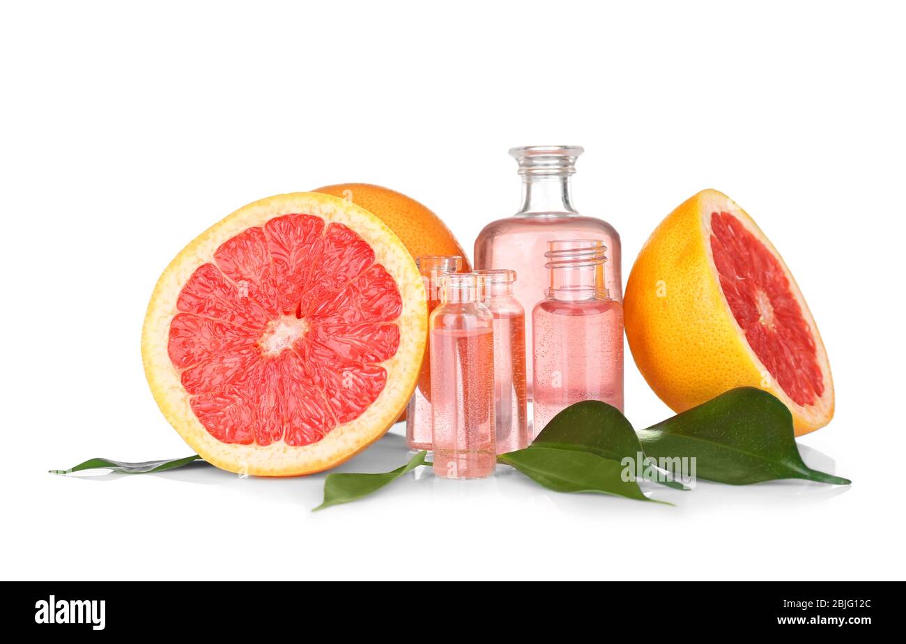 Perfume bottles and grapefruit on white background Stock Photo - Alamy