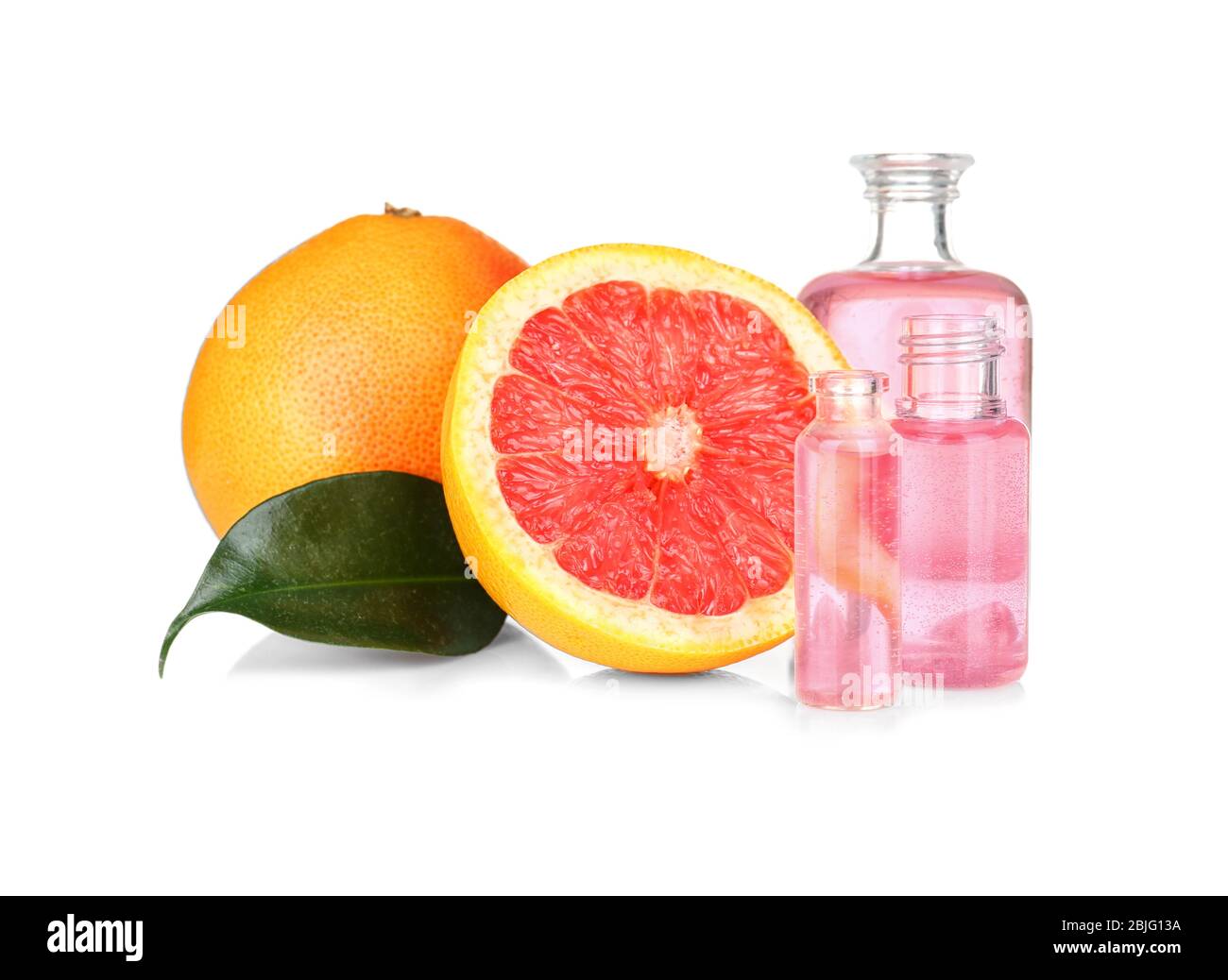 Perfume bottles and grapefruit on white background Stock Photo - Alamy