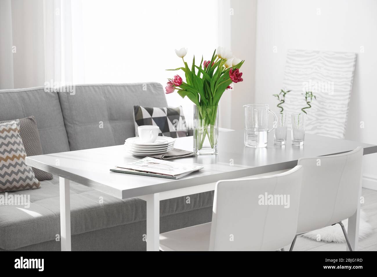Modern living room with table and chairs Stock Photo - Alamy