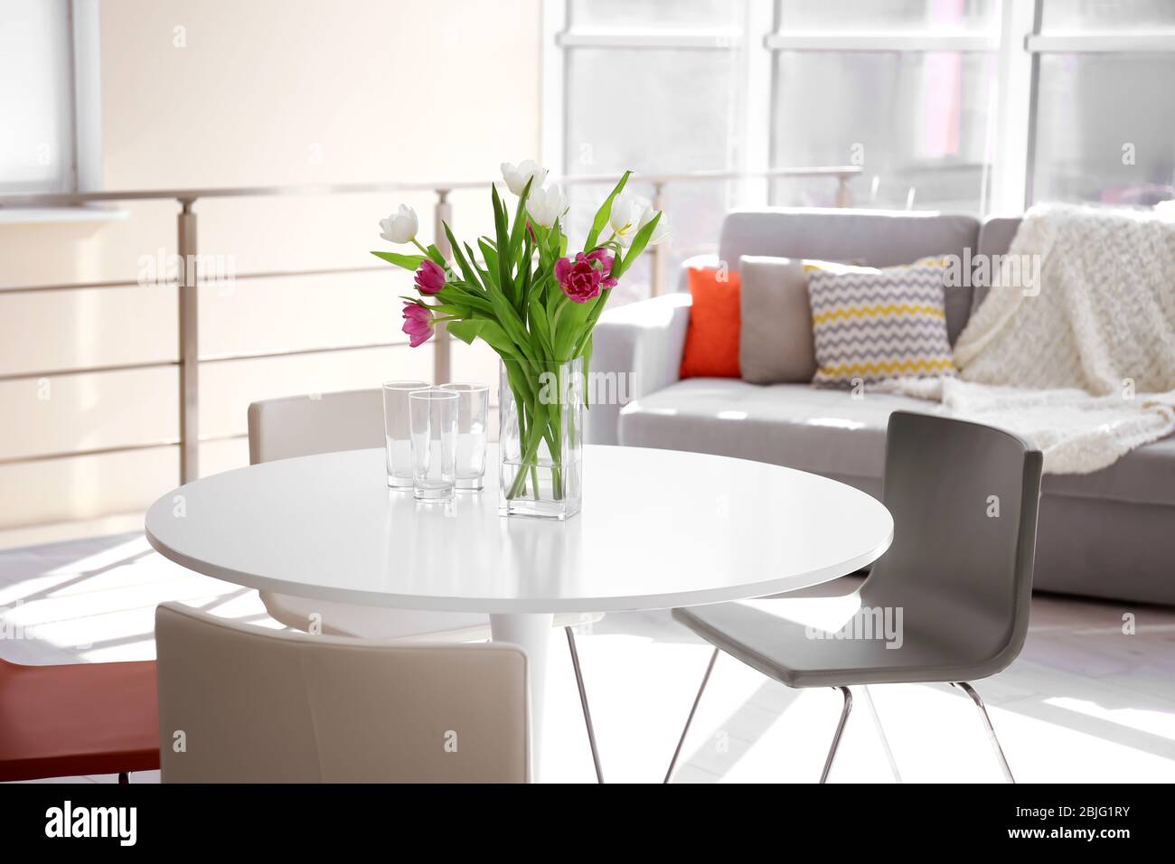 Modern living room with table and chairs Stock Photo - Alamy