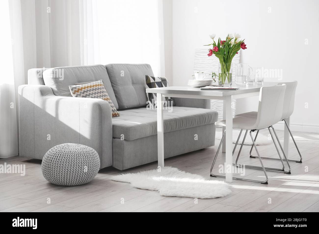 Modern living room with table and chairs Stock Photo - Alamy