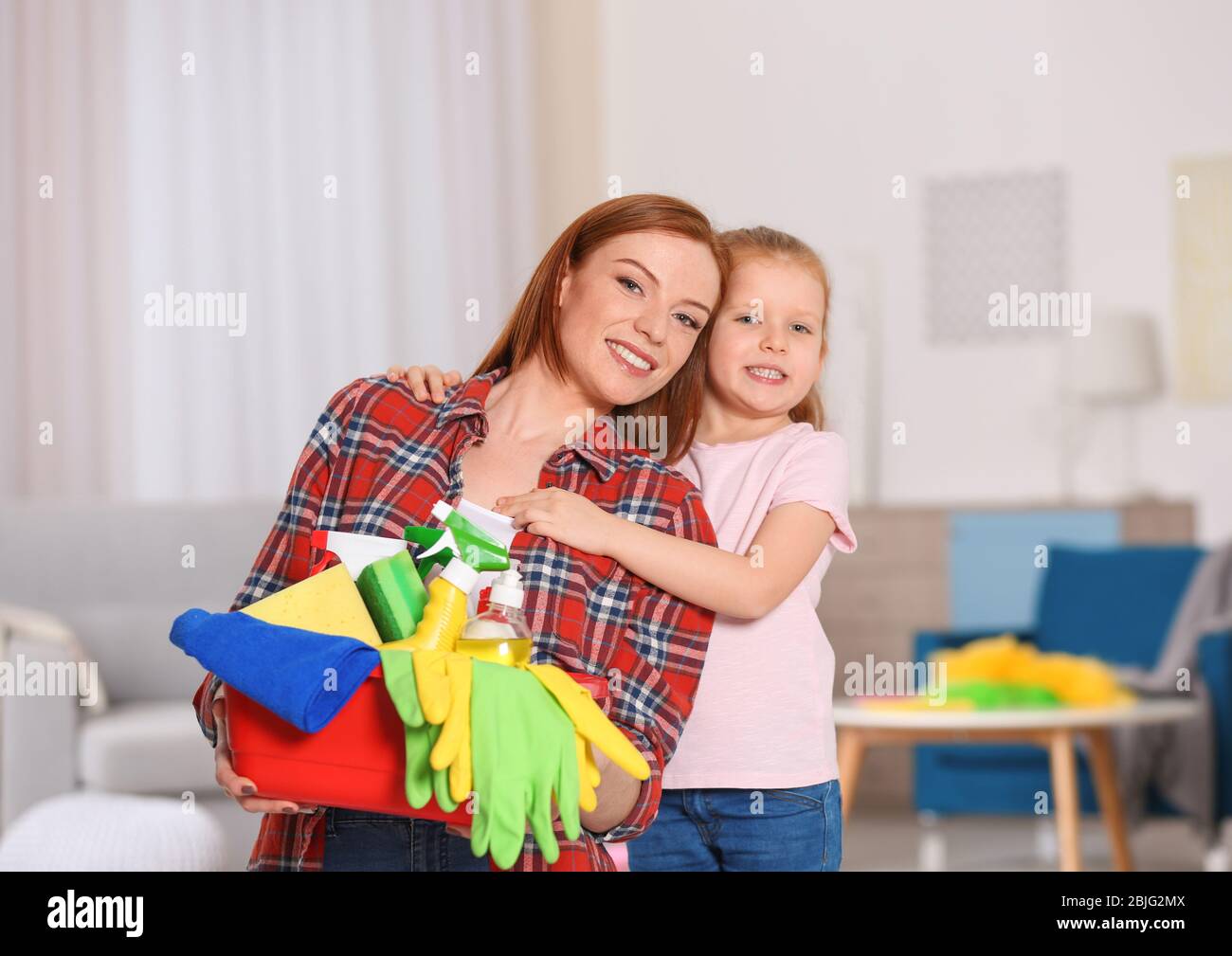 Little girl and her mother cleaning up at home Stock Photo - Alamy