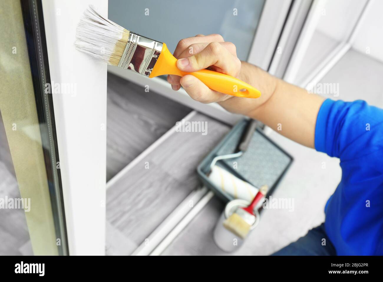 Young man painting window frame hi-res stock photography and images - Alamy