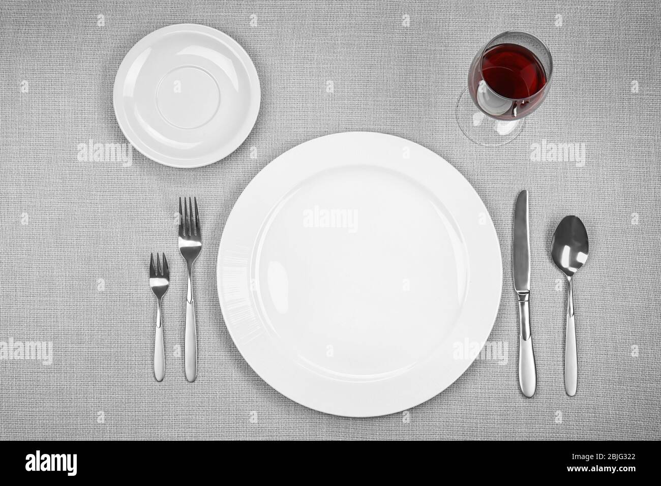 Beautiful table setting with white plates Stock Photo - Alamy