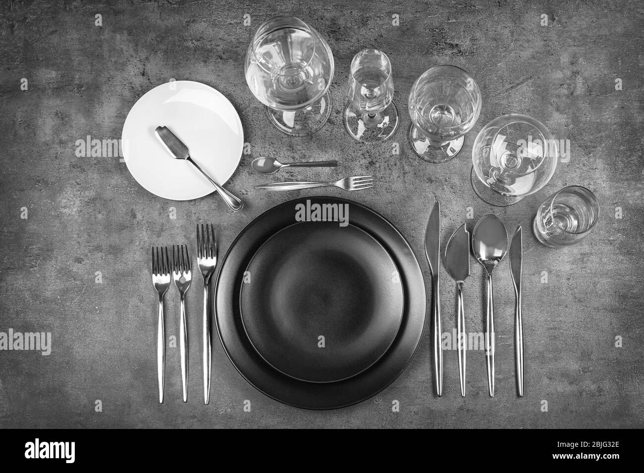 Beautiful table setting with black plates Stock Photo - Alamy