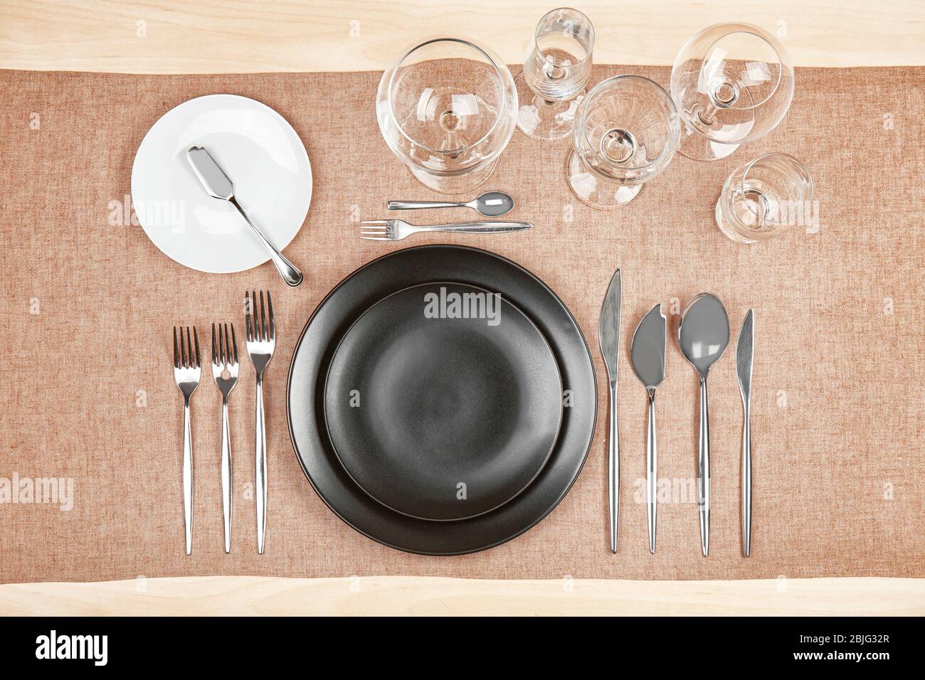 Beautiful table setting with black plates Stock Photo - Alamy