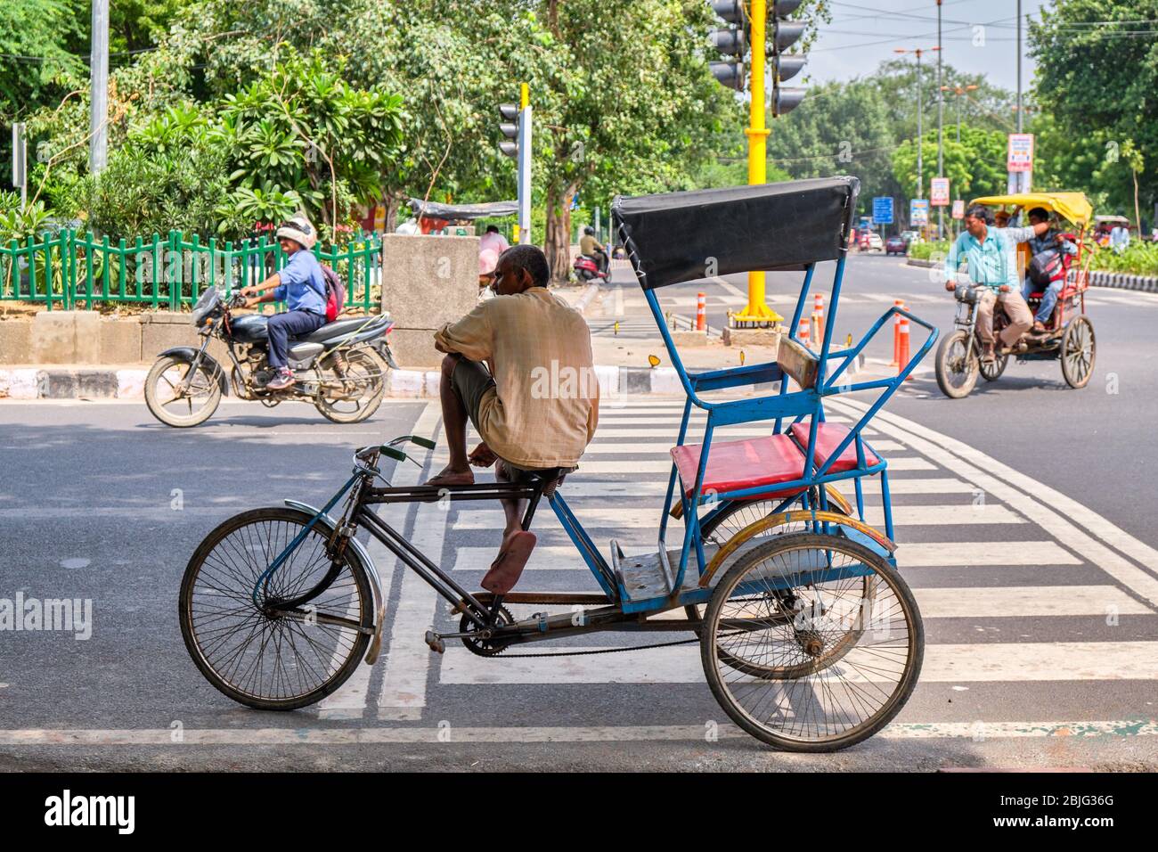 New Delhi / India - September 19, 2019: Driver sitting on his bicycle ...
