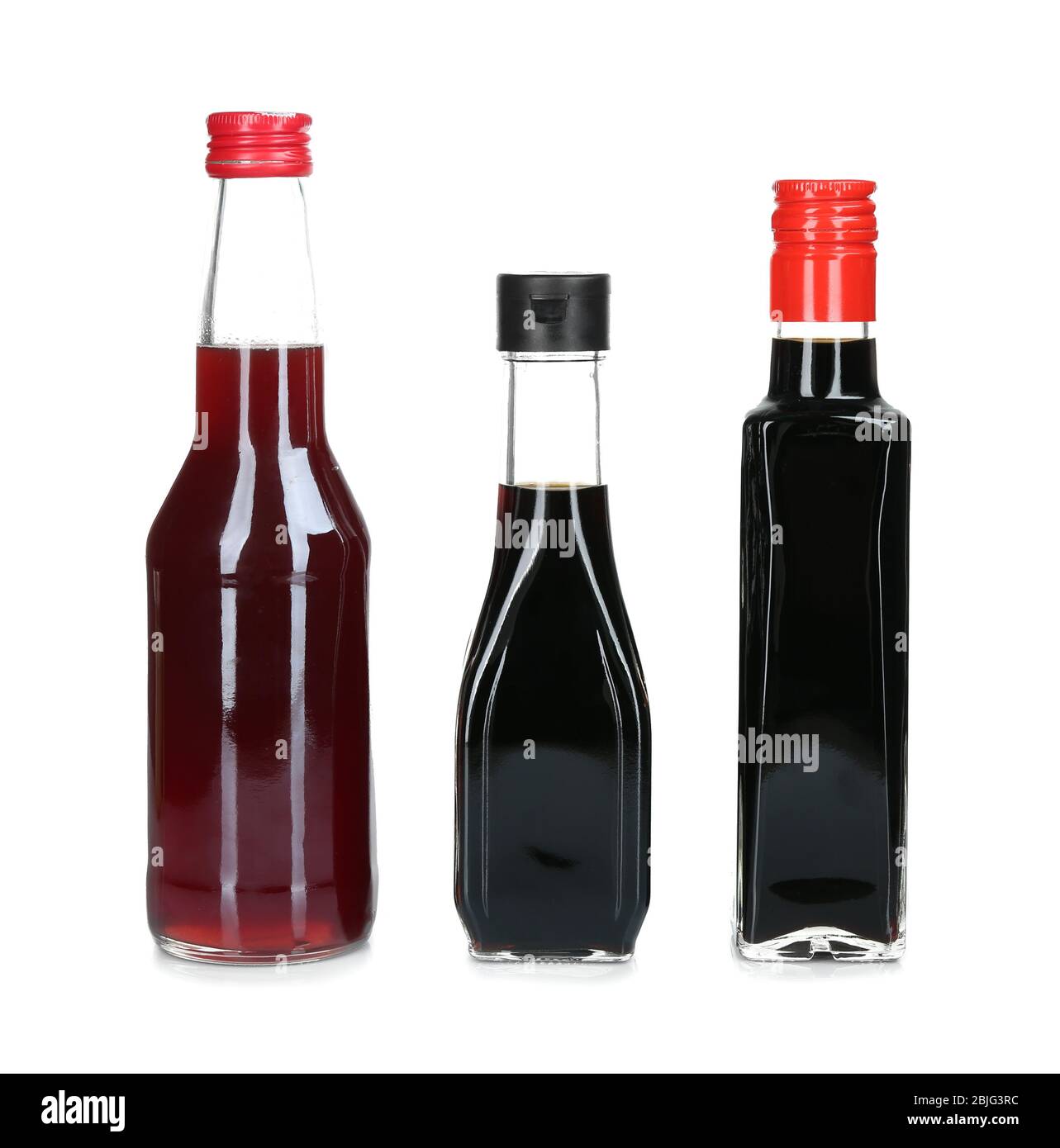 Glass bottles of liquid sauces isolated on white Stock Photo - Alamy