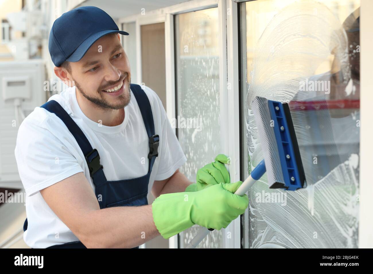 Young man washing window outdoors Stock Photo - Alamy
