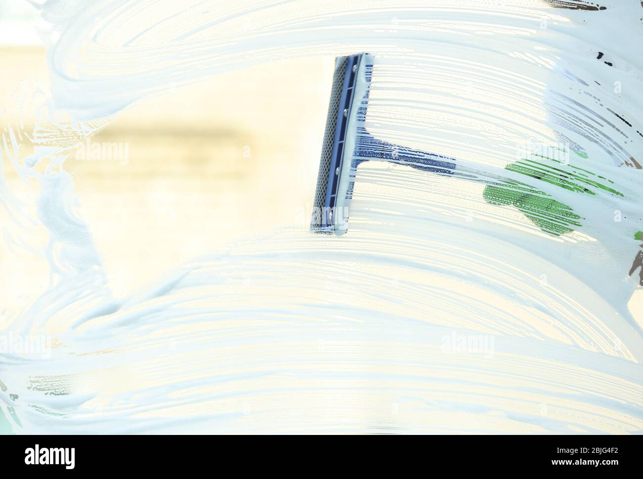 Hand of man washing window in office, view through glass Stock Photo ...