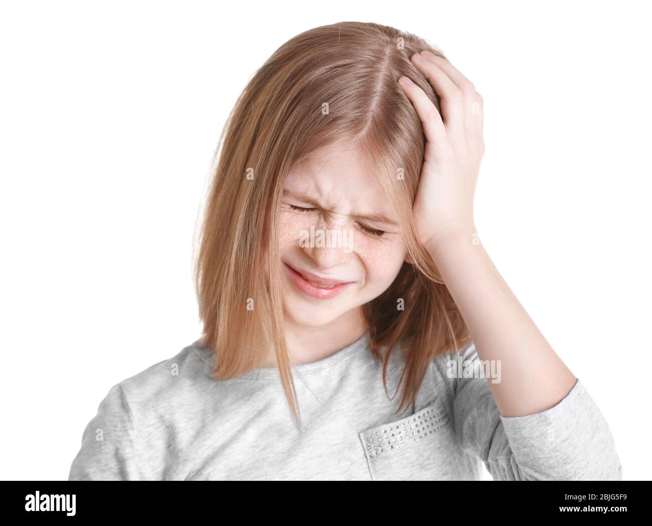 Cute girl suffering from headache on white background Stock Photo - Alamy
