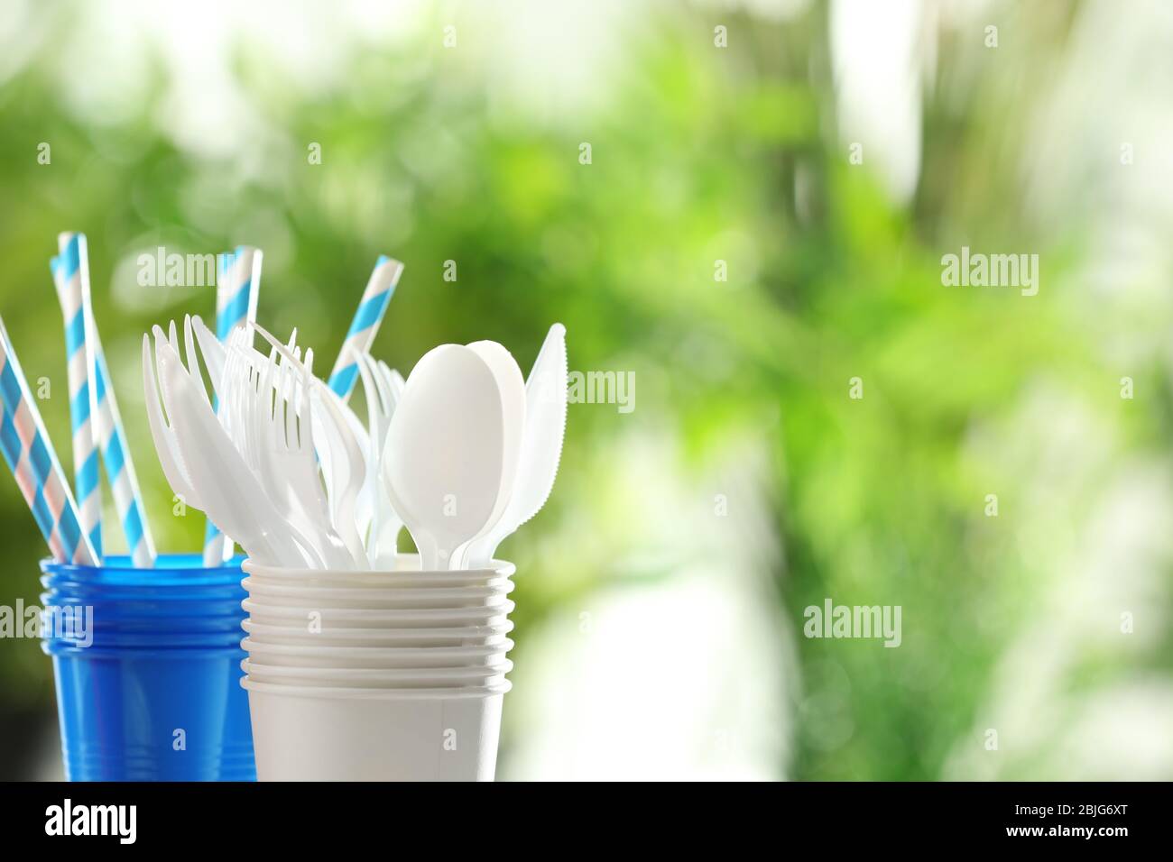 Plastic ware on blurred background outdoors Stock Photo - Alamy