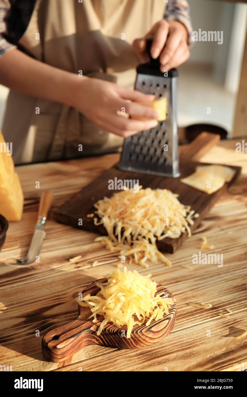 Woman grating cheese hi-res stock photography and images - Alamy