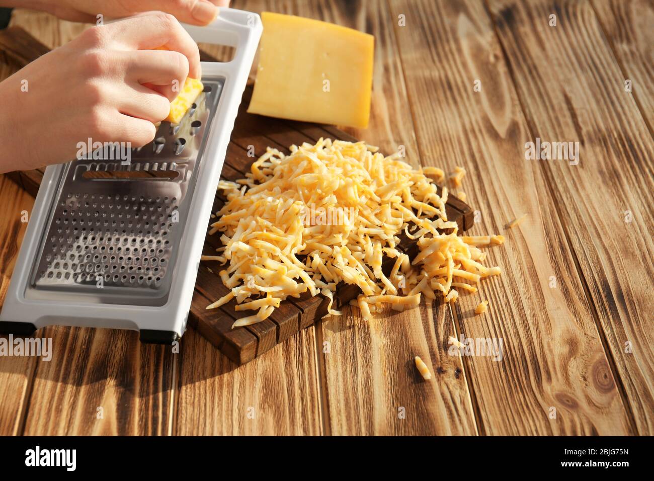 Woman grating cheese hi-res stock photography and images - Alamy